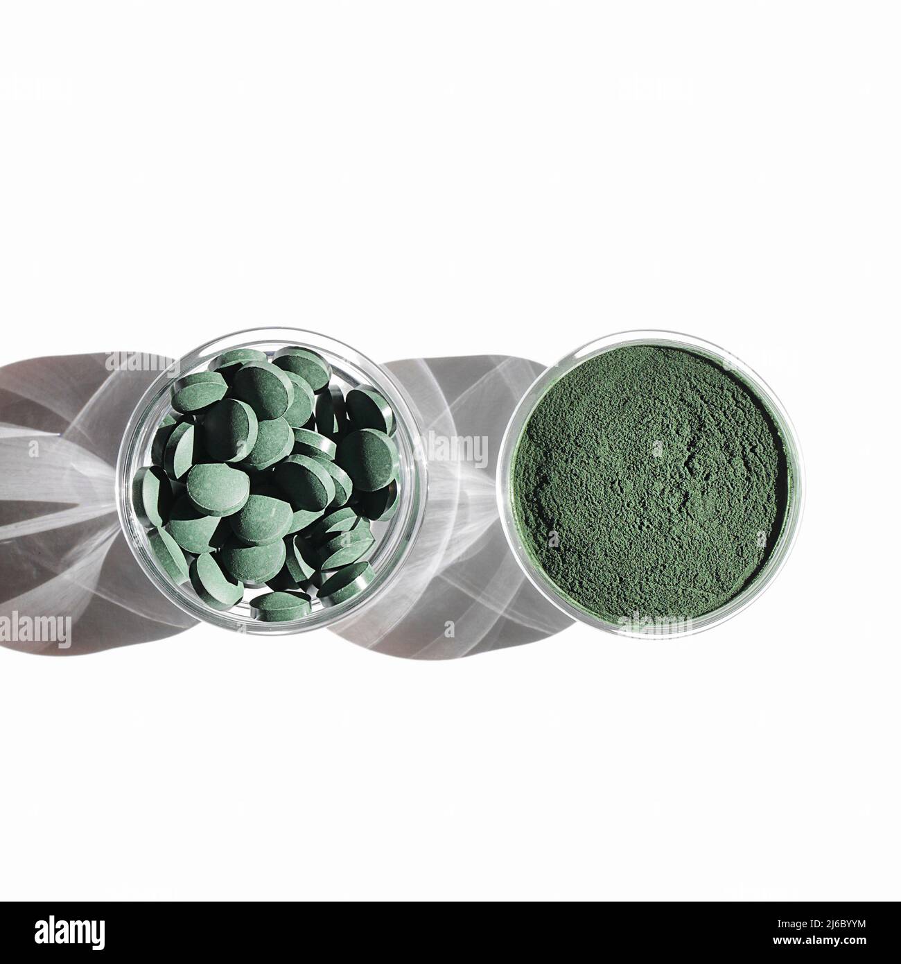 natural additives and superfood. green spirulina algae powder and pills ...