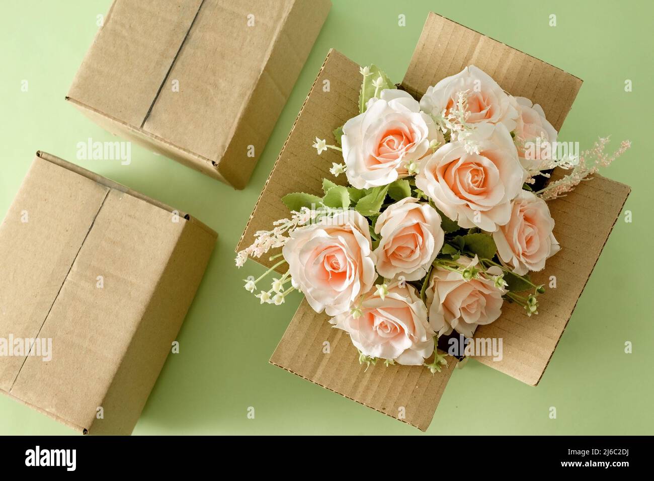 A beautiful blooming bouquet of pink roses in a parcel delivery ...