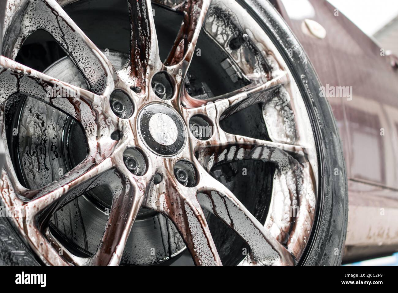 dirty car wheel, rim with mud and dirty fluid running down the alloy ...