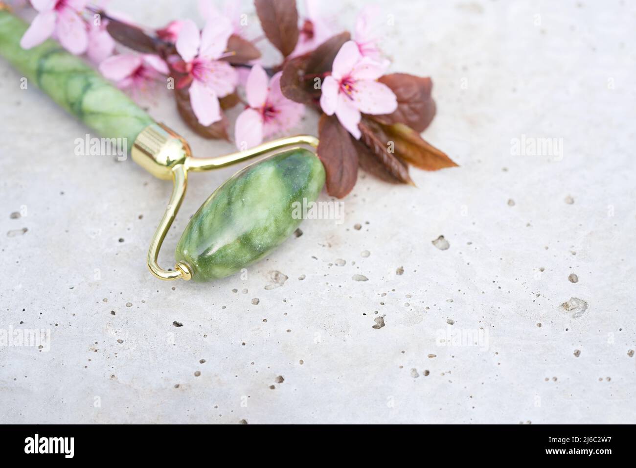 Facial massage kit - jade gua sha face roller on stone concrete ...