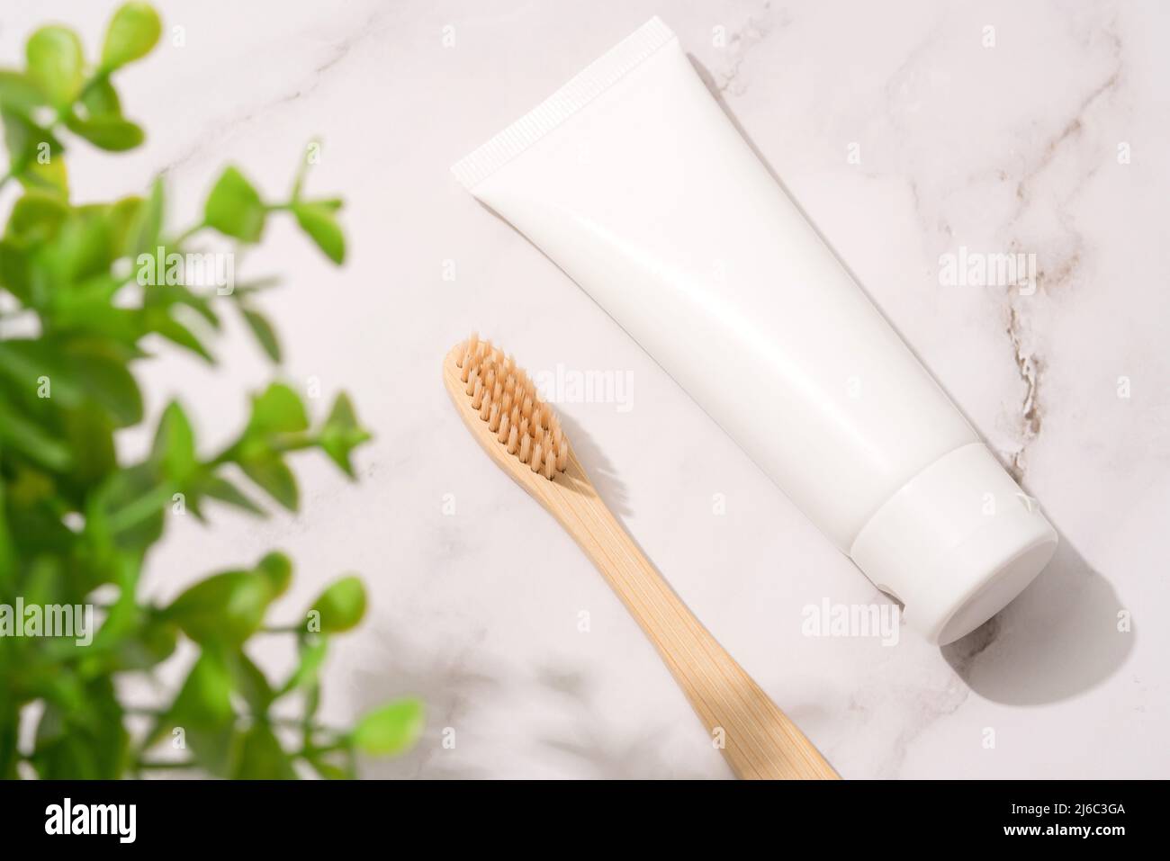 Wooden bamboo toothbrush and tube with organic mineral toothpaste on ...