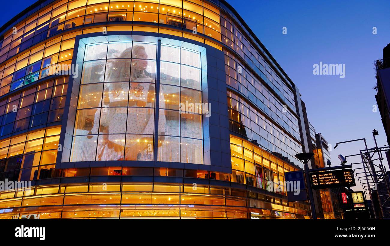 Modern glass building with advertising screen of the clothing ...