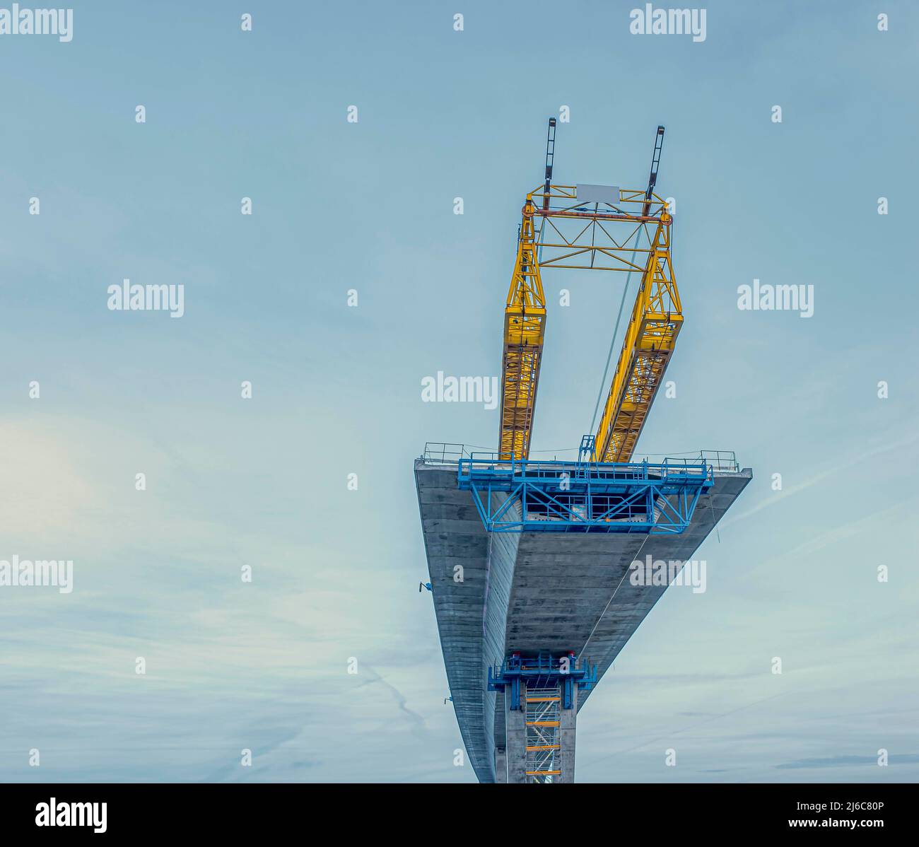 a yellow crane on the Crown princess Mary bridge under construction ...