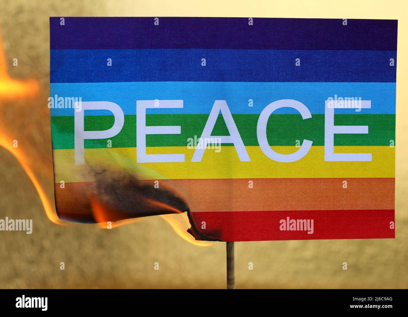 flag with the text PEACE as it burns with Fire on golden background ...