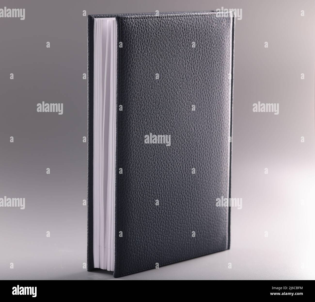 Close-up of black leather notebook or diary on grey background. Small ...
