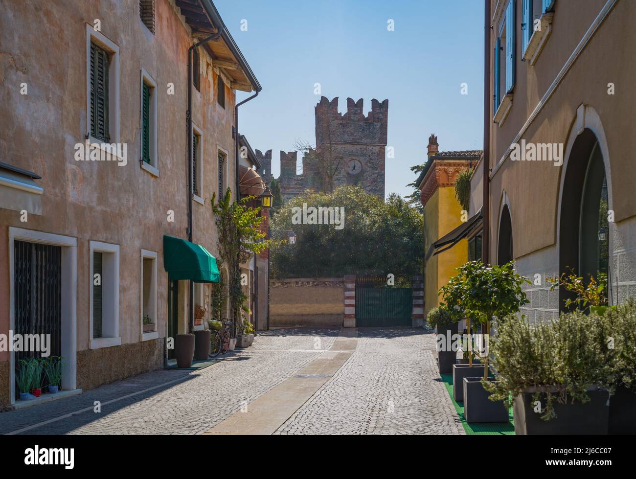 Italy, Lazise, a street of the old town with the Scaligero castle in ...