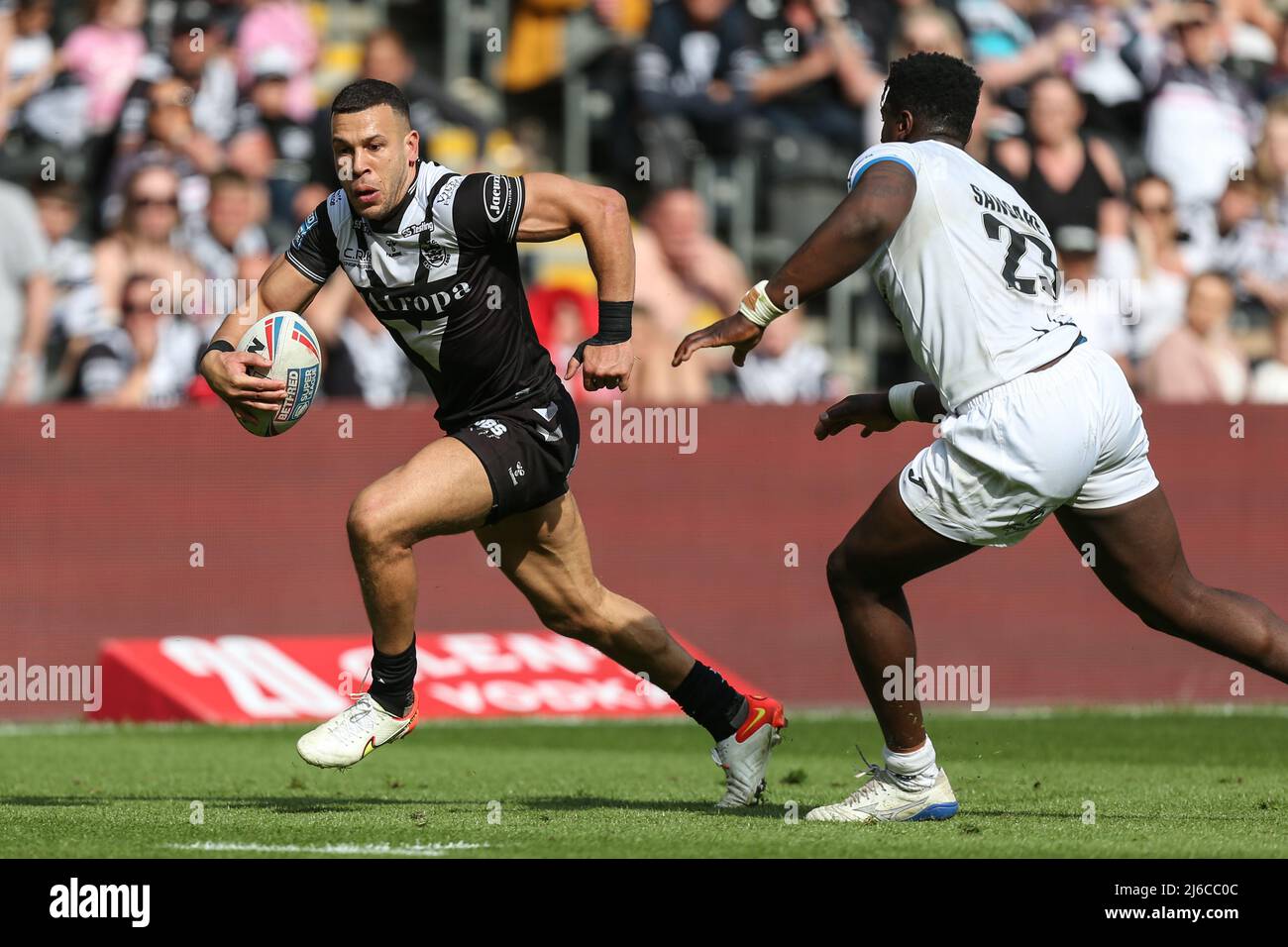 Carlos Tuimavave #3 of Hull FC goes past Justin Sangare #23 of Toulouse ...