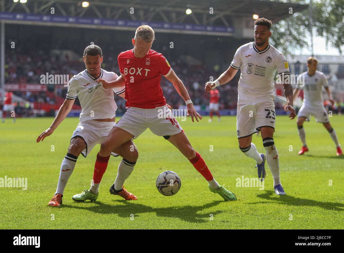 Sam Surridge #16 of Nottingham Forest holds off Joel Latibeaudiere #22 ...