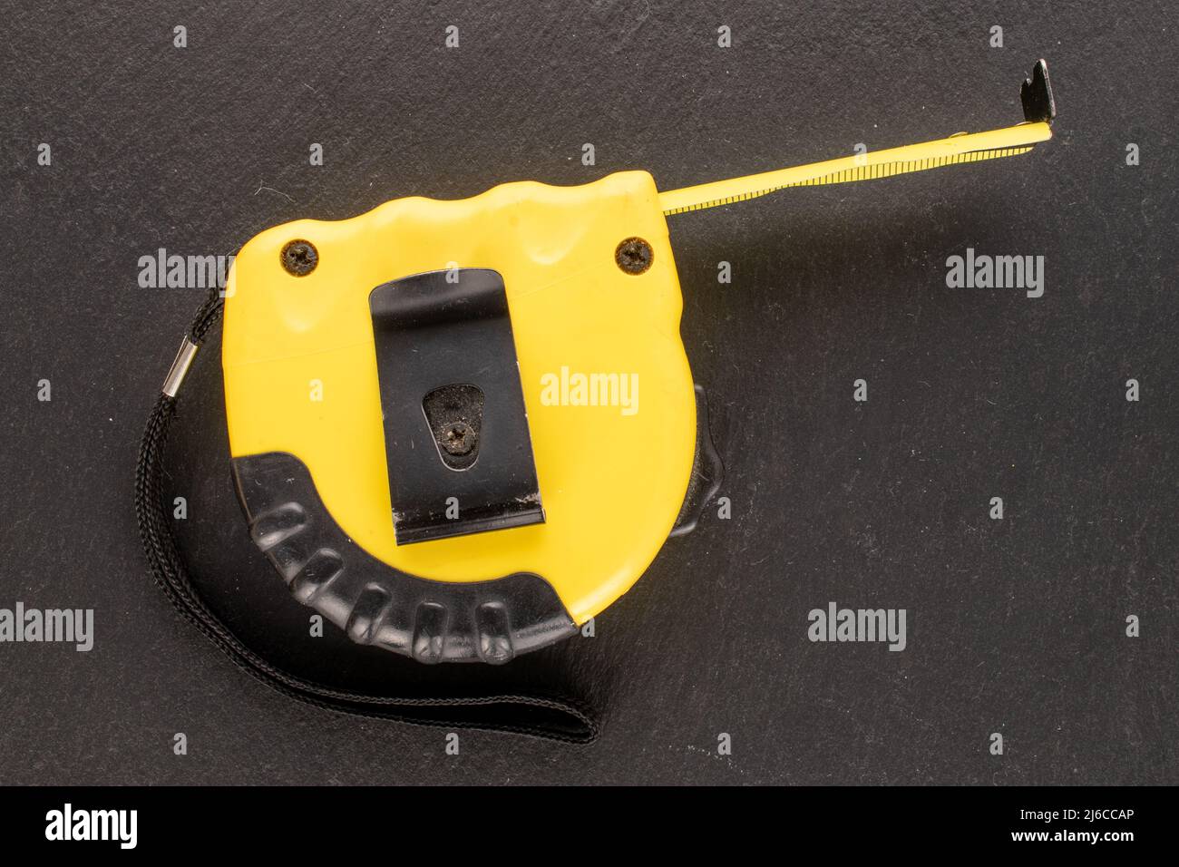 One construction tape measure on a slate stone, macro, top view Stock ...