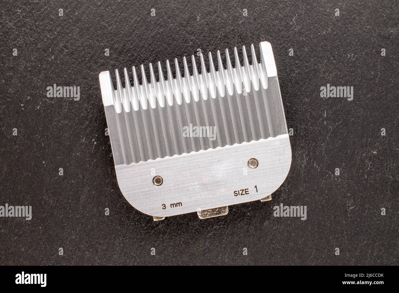 One metal clipper attachment on a slate stone, macro, top view Stock ...