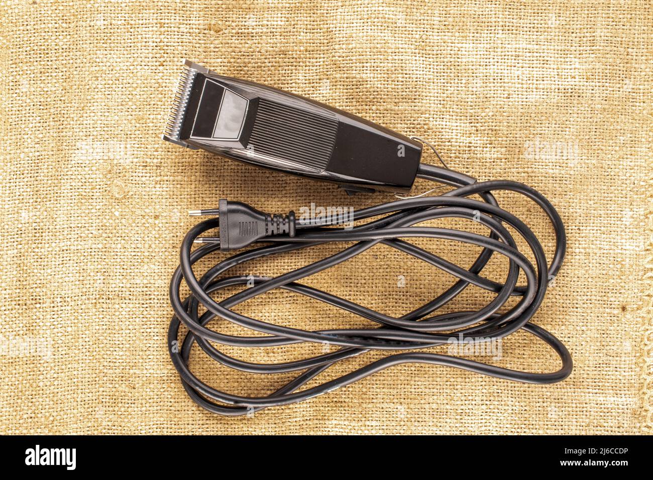 One electric clipper on jute fabric, macro, top view Stock Photo - Alamy