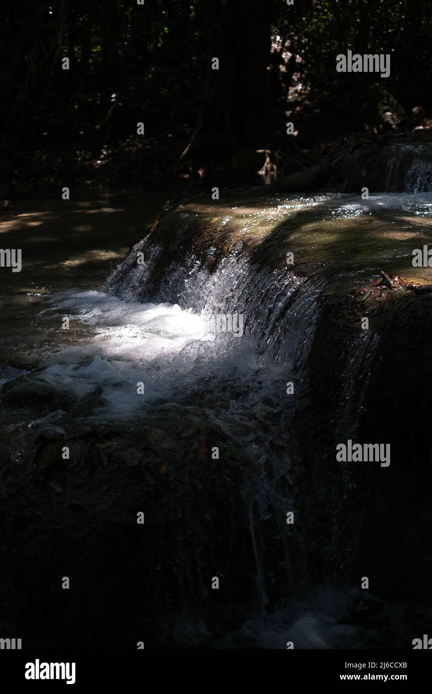 A small forest waterfall with perfectly shaped streams of water Stock ...