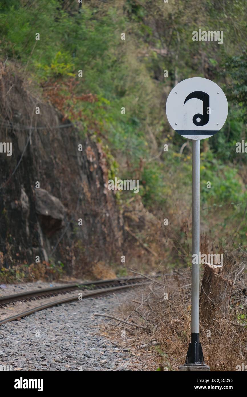 A strange native road sign on an old narrow gauge railway in Thailand ...