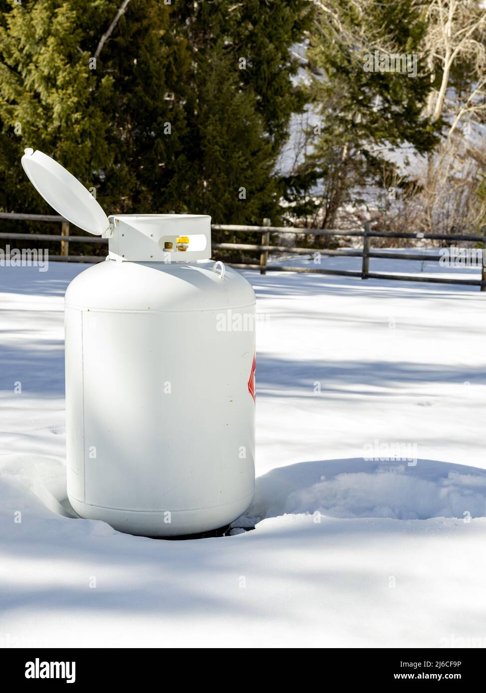 Outdoors tank for propane in inter with a forest of trees Stock Photo ...