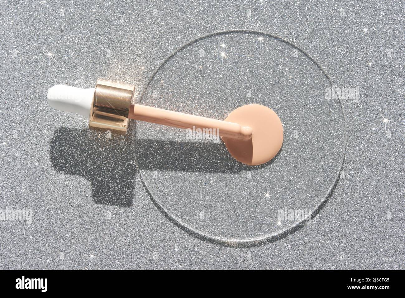 Beige foundation texture swatch. Cream drop with silver sparkles and ...