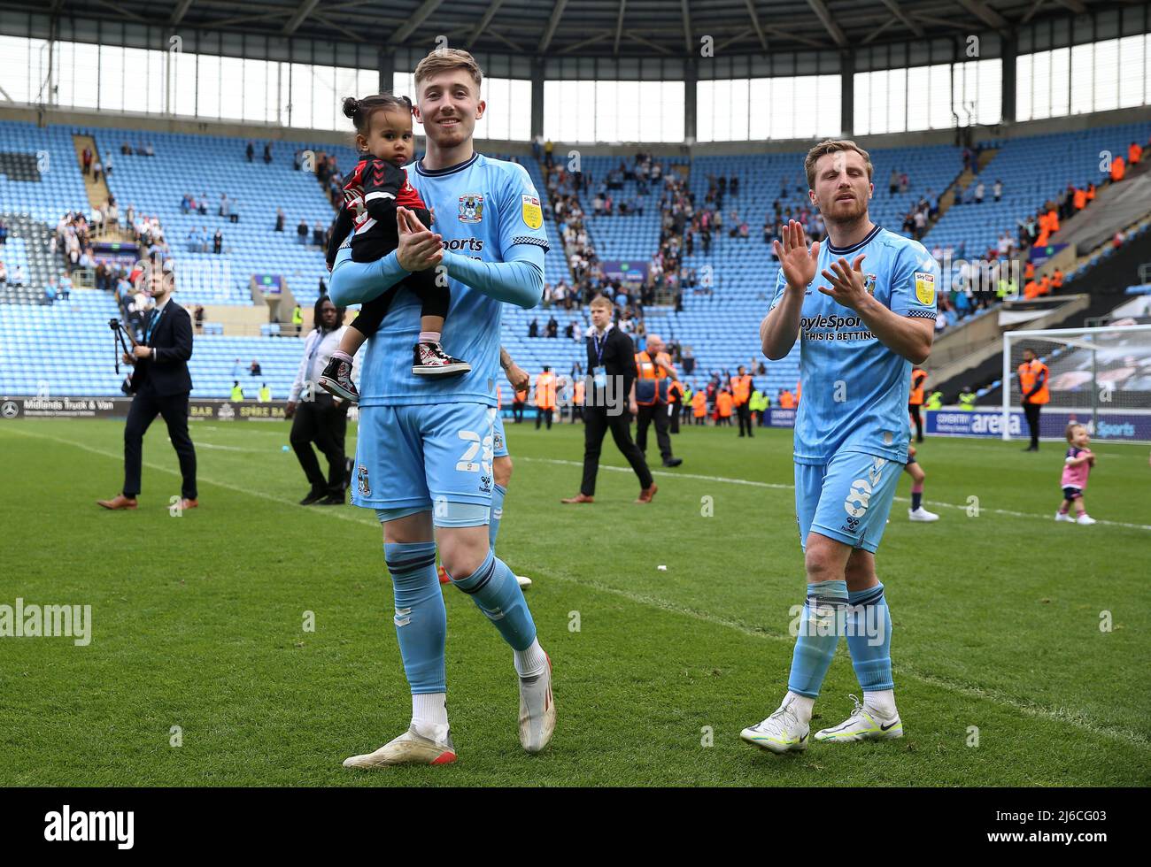 Coventry City's Josh Eccles, his child and Jamie Allen on a lap of ...