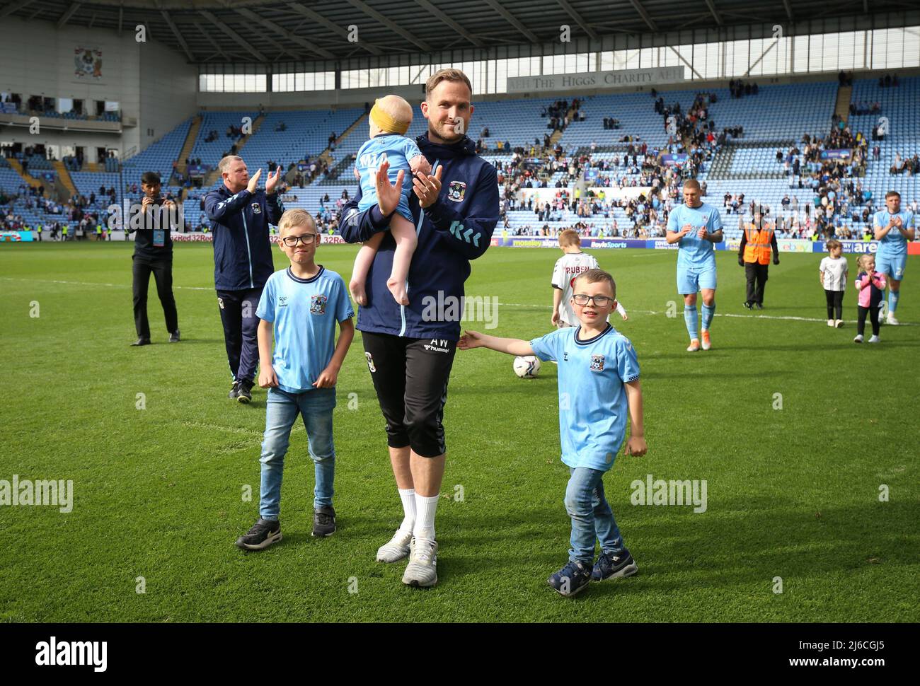 Coventry City goalkeeping coach Aled Williams and his children on a lap ...