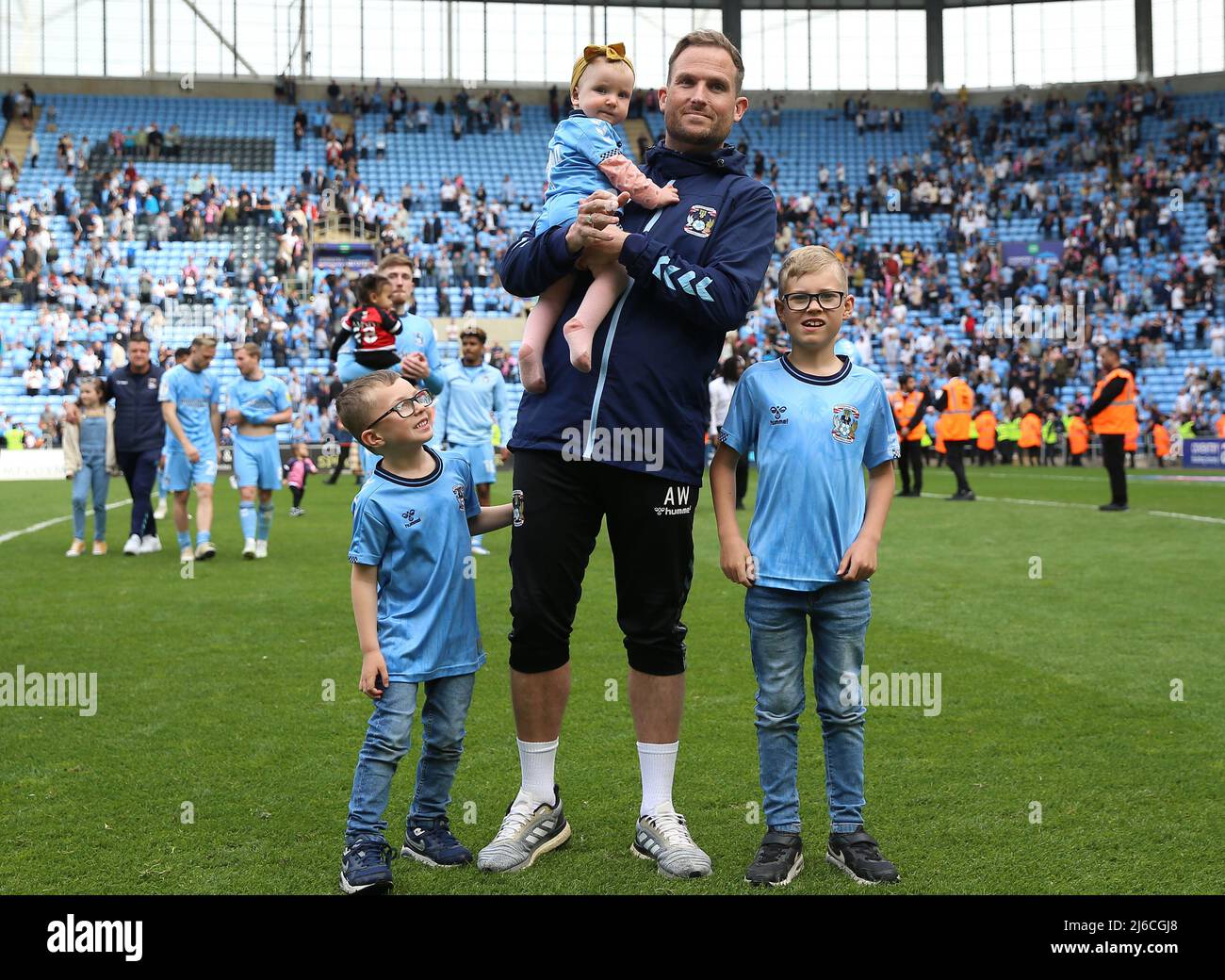 Coventry City goalkeeping coach Aled Williams and his children on a lap ...