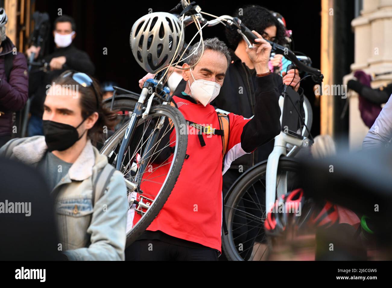 A cyclist carries his bicycle out of the Cathedral after attending the ...