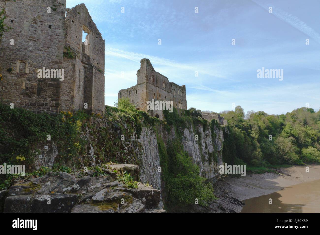 The ruins of Chepstow Castle rise above the Wye River estuary, Chepstow ...