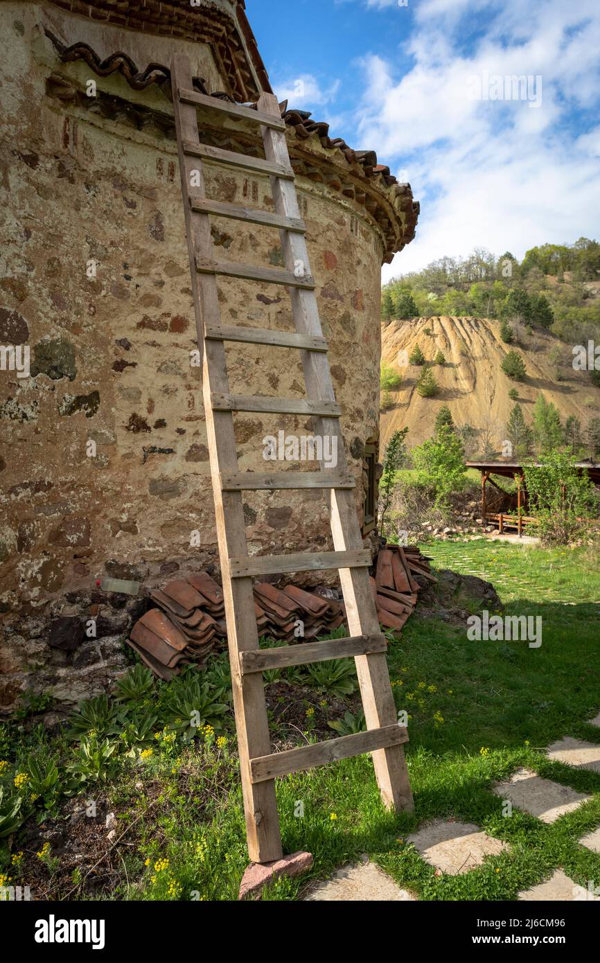 An old wooden ladder supported by a stone wall of an Orthodox church ...