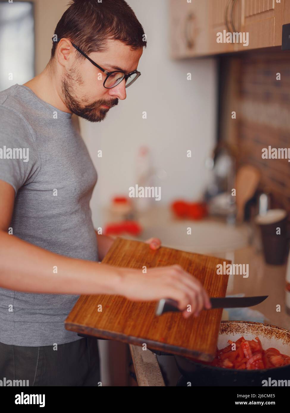 man preparing homemade tomato sauce for pizza or pasta. happy satisfied ...