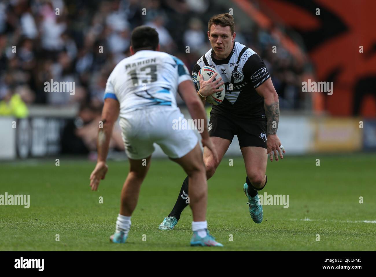 Jordan Lane #13 of Hull FC runs at Anthony Marion #13 of Toulouse ...