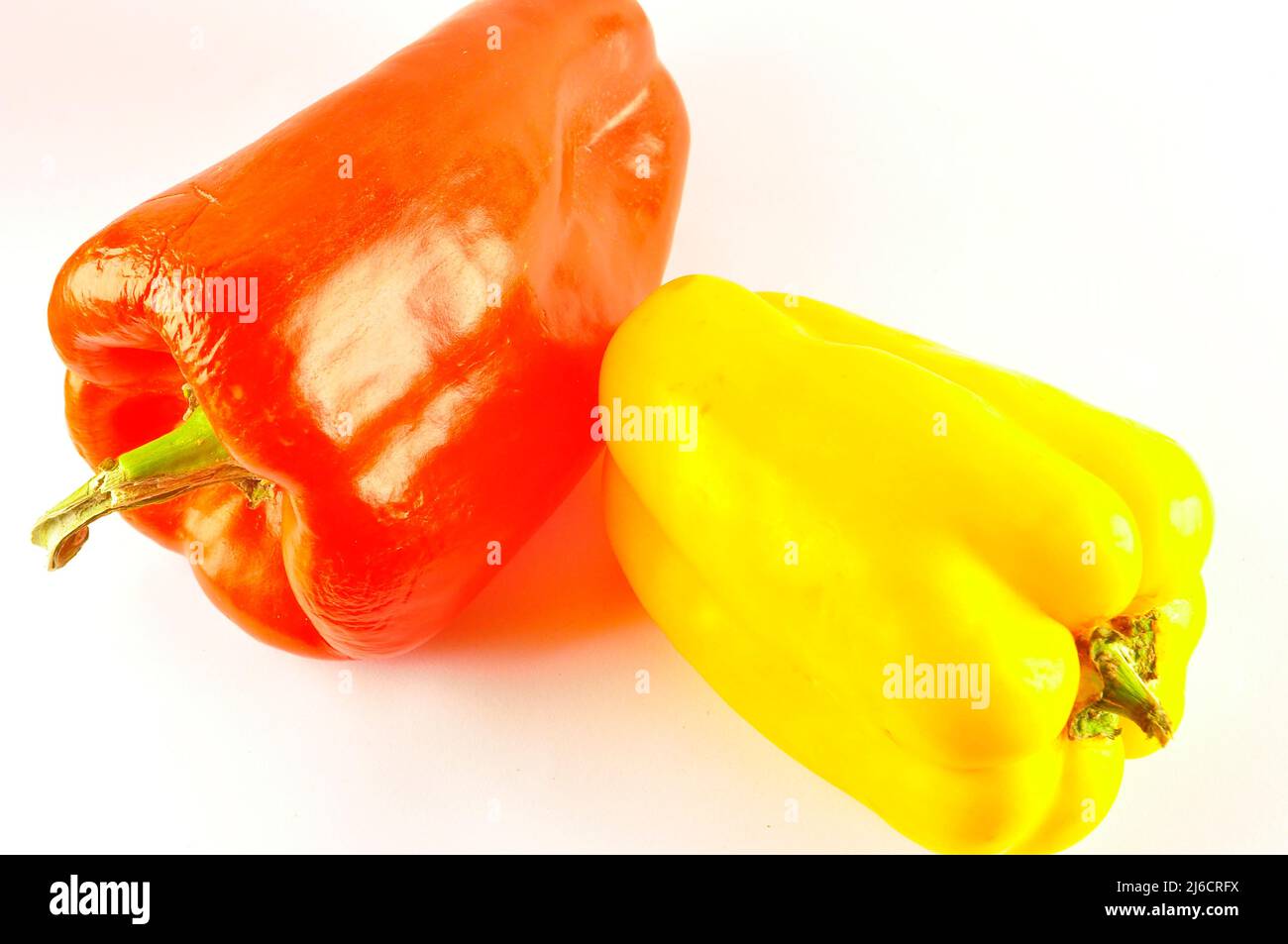 Red and yellow pepper on white background Stock Photo - Alamy