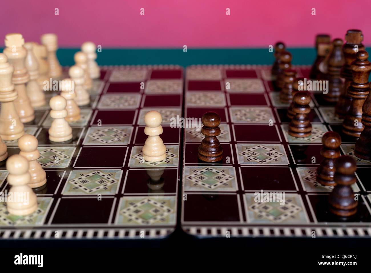 Two pawns met on a chess board Stock Photo - Alamy