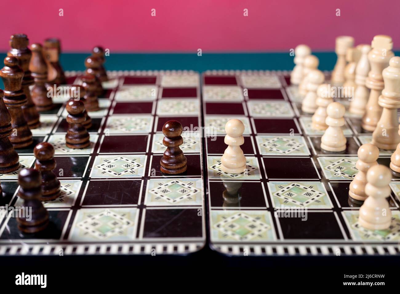 Two pawns met on a chess board Stock Photo - Alamy