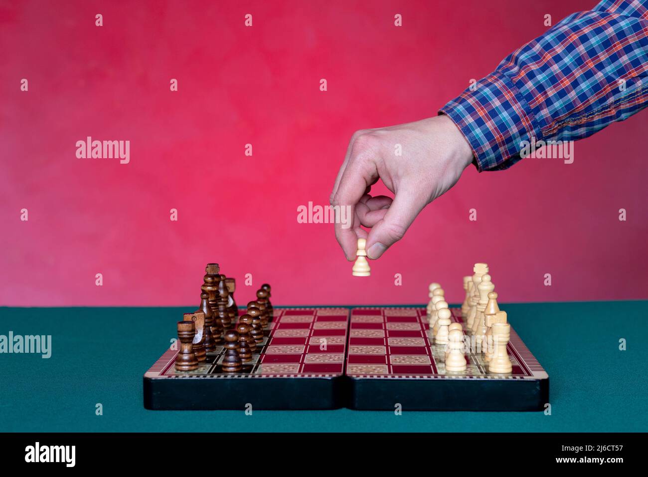 Hand rearranging a chess piece. Classic game Stock Photo - Alamy