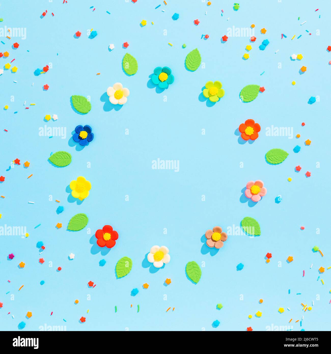 Multi colored multi shaped sprinkles on blue Stock Photo - Alamy