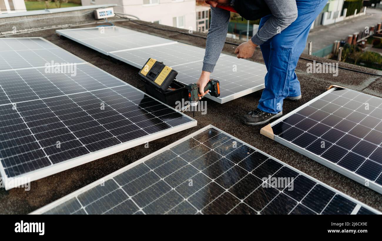 Technical engineer installing solar photovoltaic panel system using ...