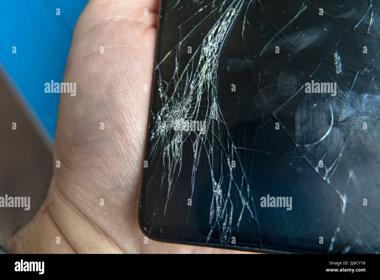 a broken mobile phone screen in the master's hand Stock Photo - Alamy
