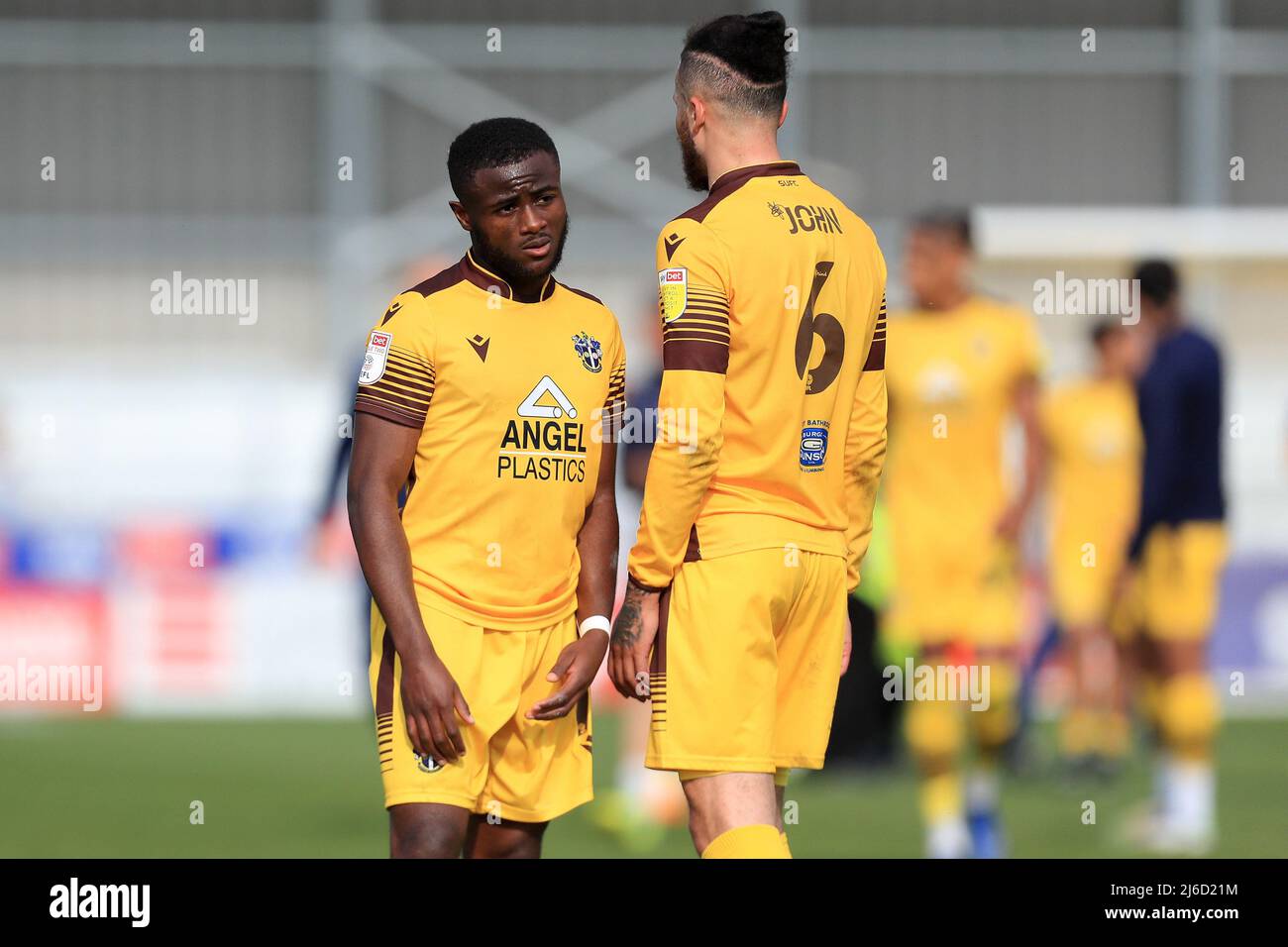 A distraught David Ajiboye #7 of Sutton United with Louis John #6 of ...