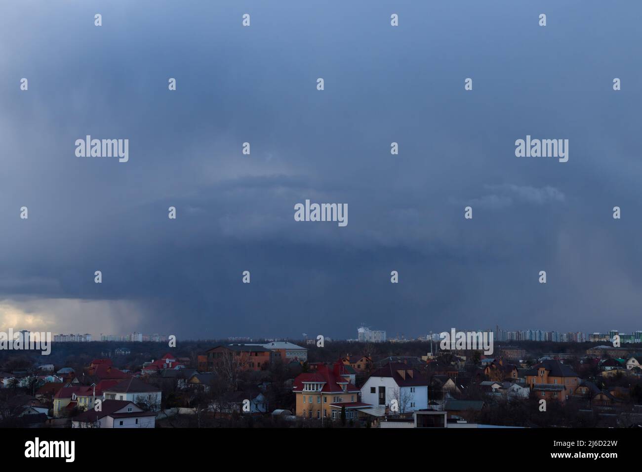 dark thundercloud over the outskirts of the city, summer, atmospheric ...