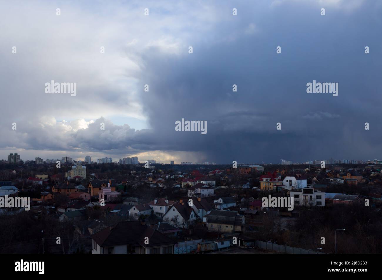 dark thundercloud over the outskirts of the city, summer, atmospheric ...