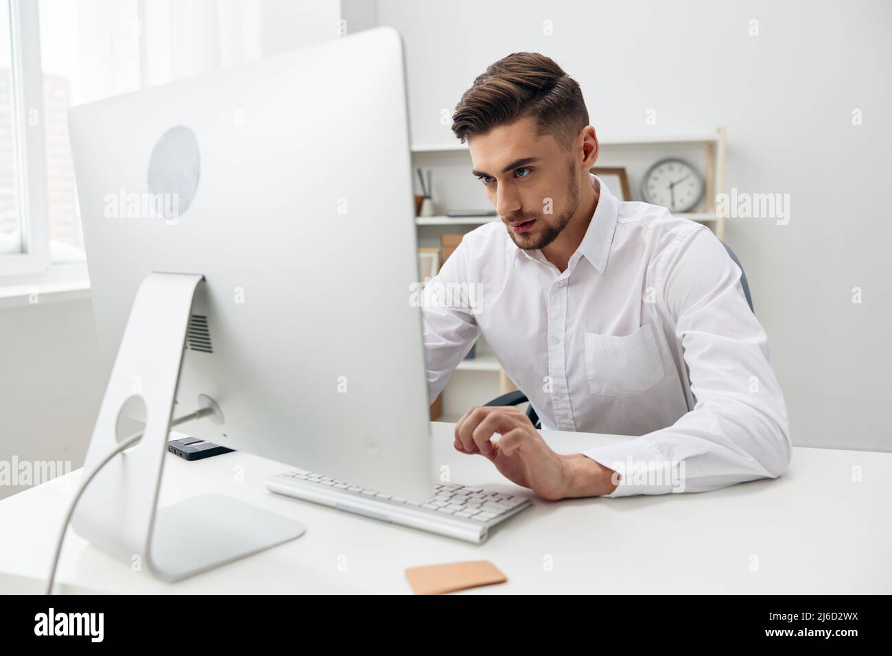 businessmen sitting at a desk in front of a computer with a keyboard ...