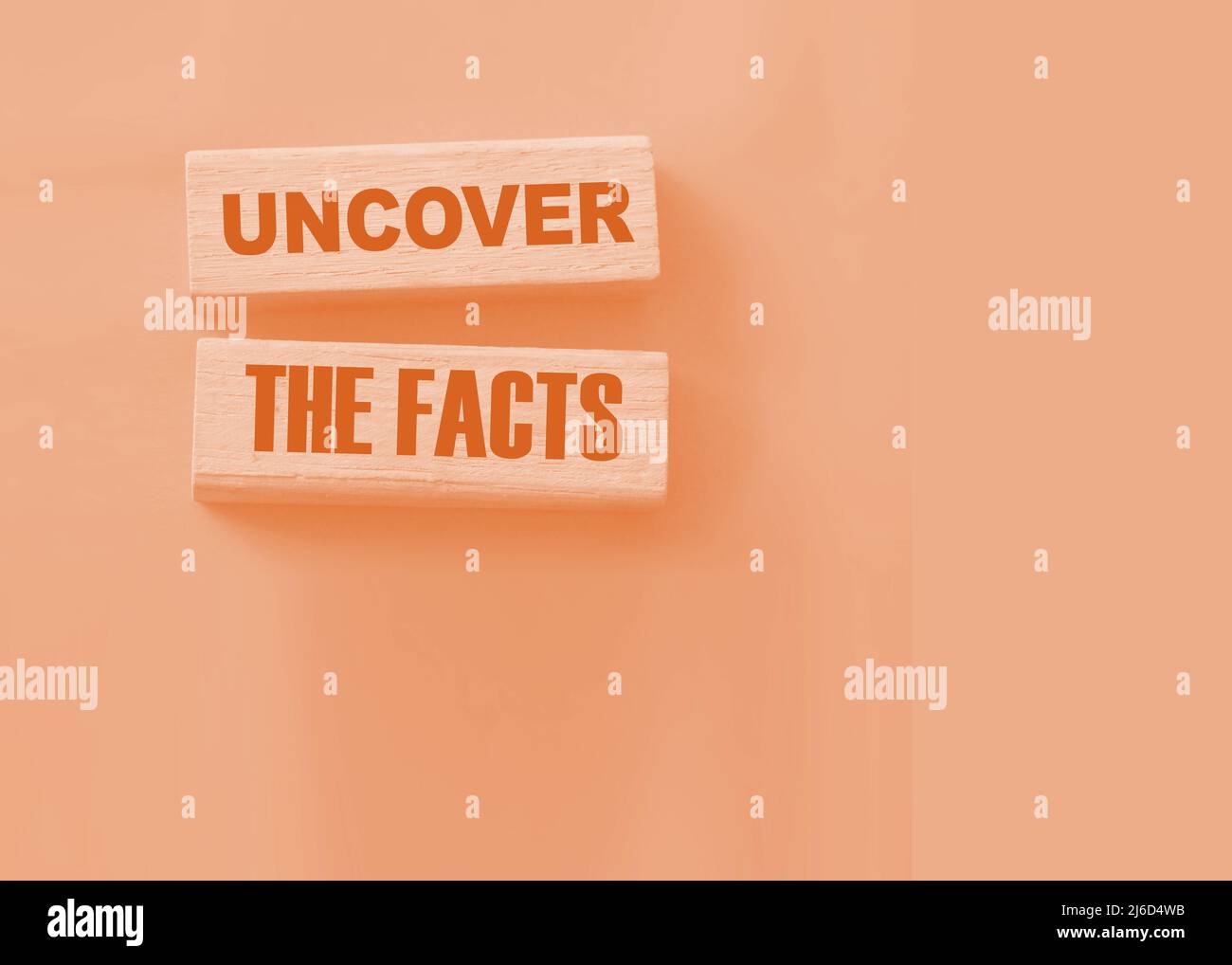 Uncover the facts word on wooden blocks on red background. Fake or real ...