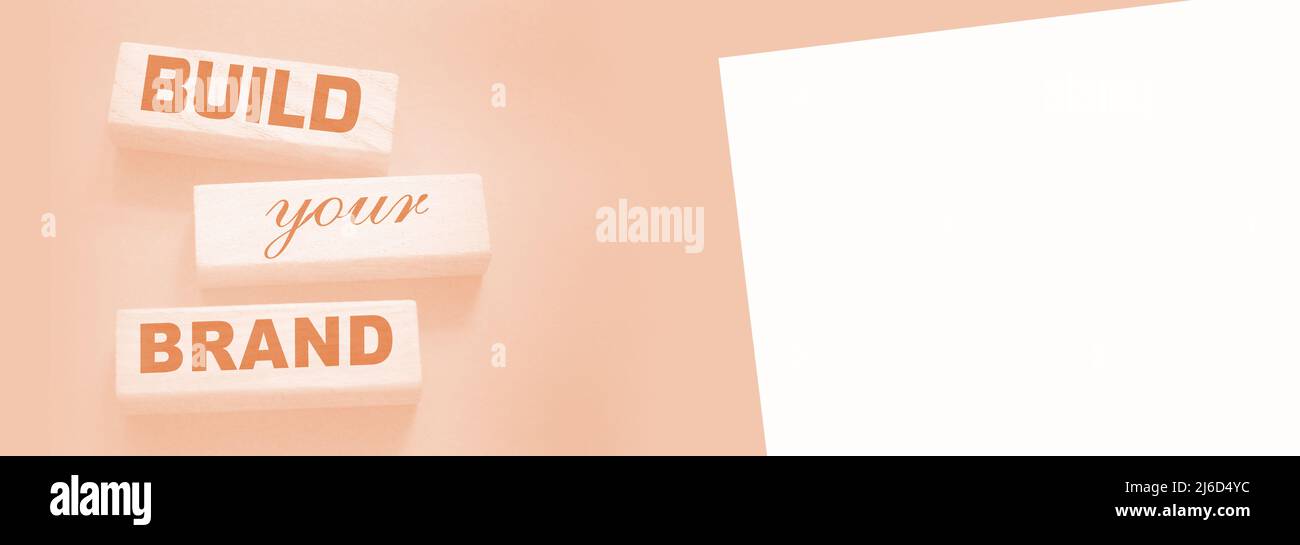 Phrase BUILD YOUR BRAND written on wooden blocks. With vintage styled ...