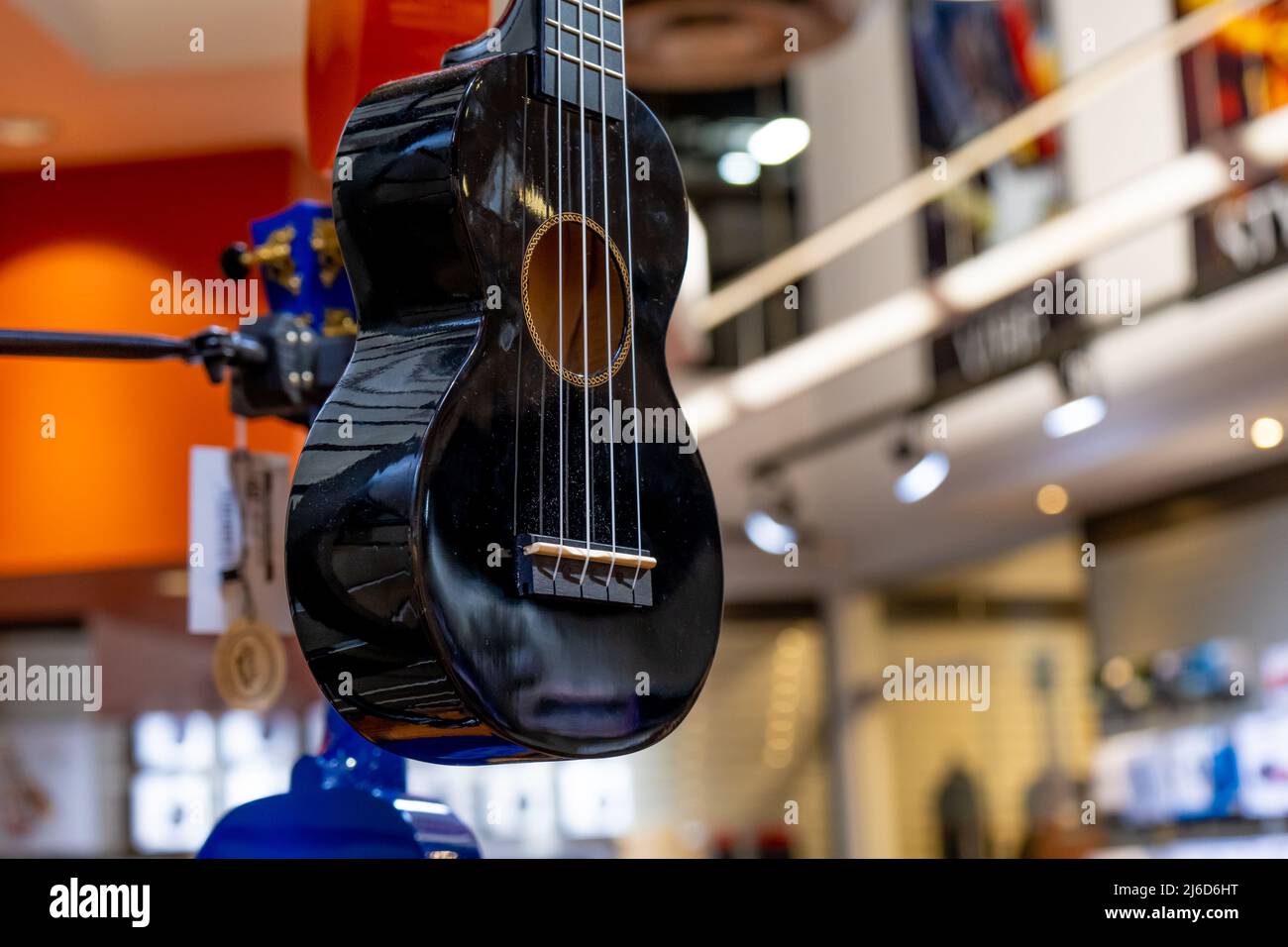 Guitars on display in music instruments store in a mall Stock Photo - Alamy