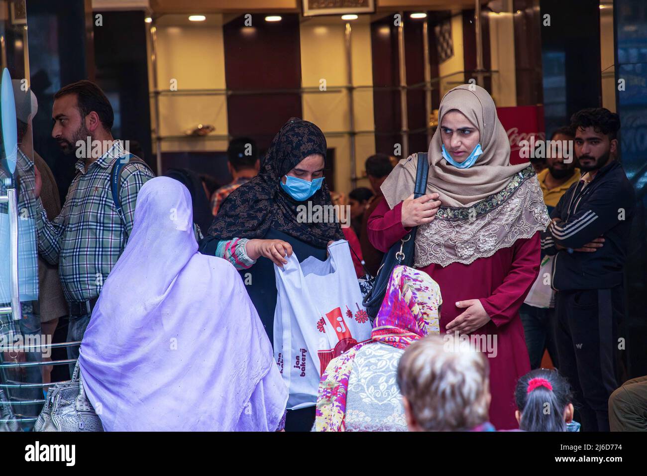 Kashmiri people buy bakery items ahead of the Muslim festival Eid-al-Fitr at a local market in ...