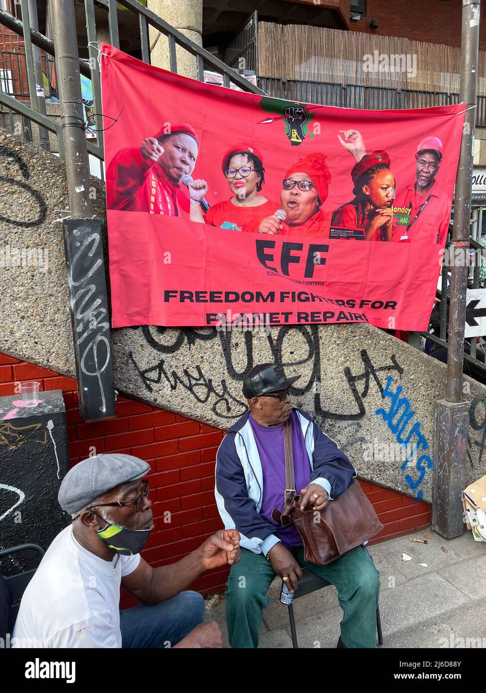 An economic Freedom Fighters banner is seen as people listen to ...