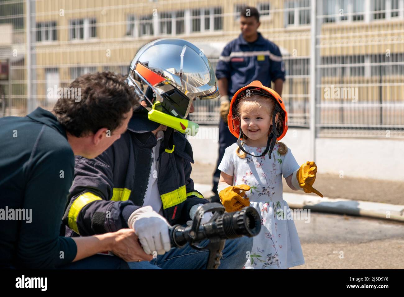 Fire uniformed father teaches his daughter Firefighter training Stock ...