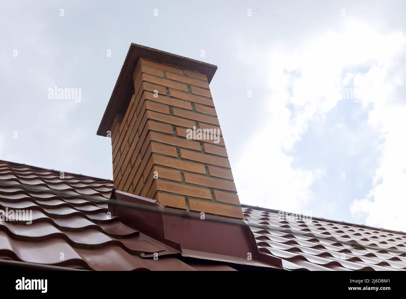 Chimney on of roofing materials red metal roof tile sheets Stock Photo ...