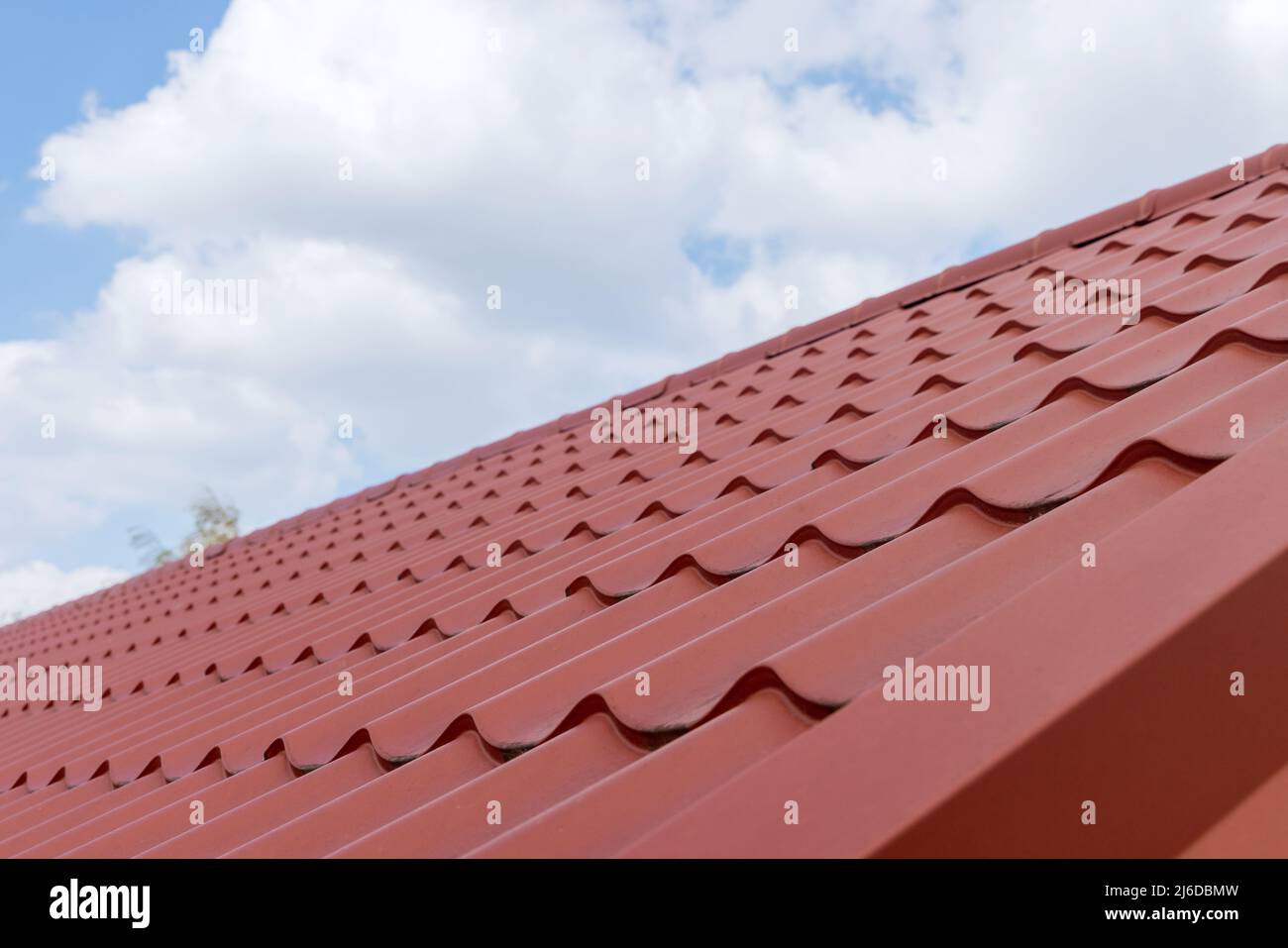 Modern roof covered with effect coated red metal roof tile Stock Photo ...