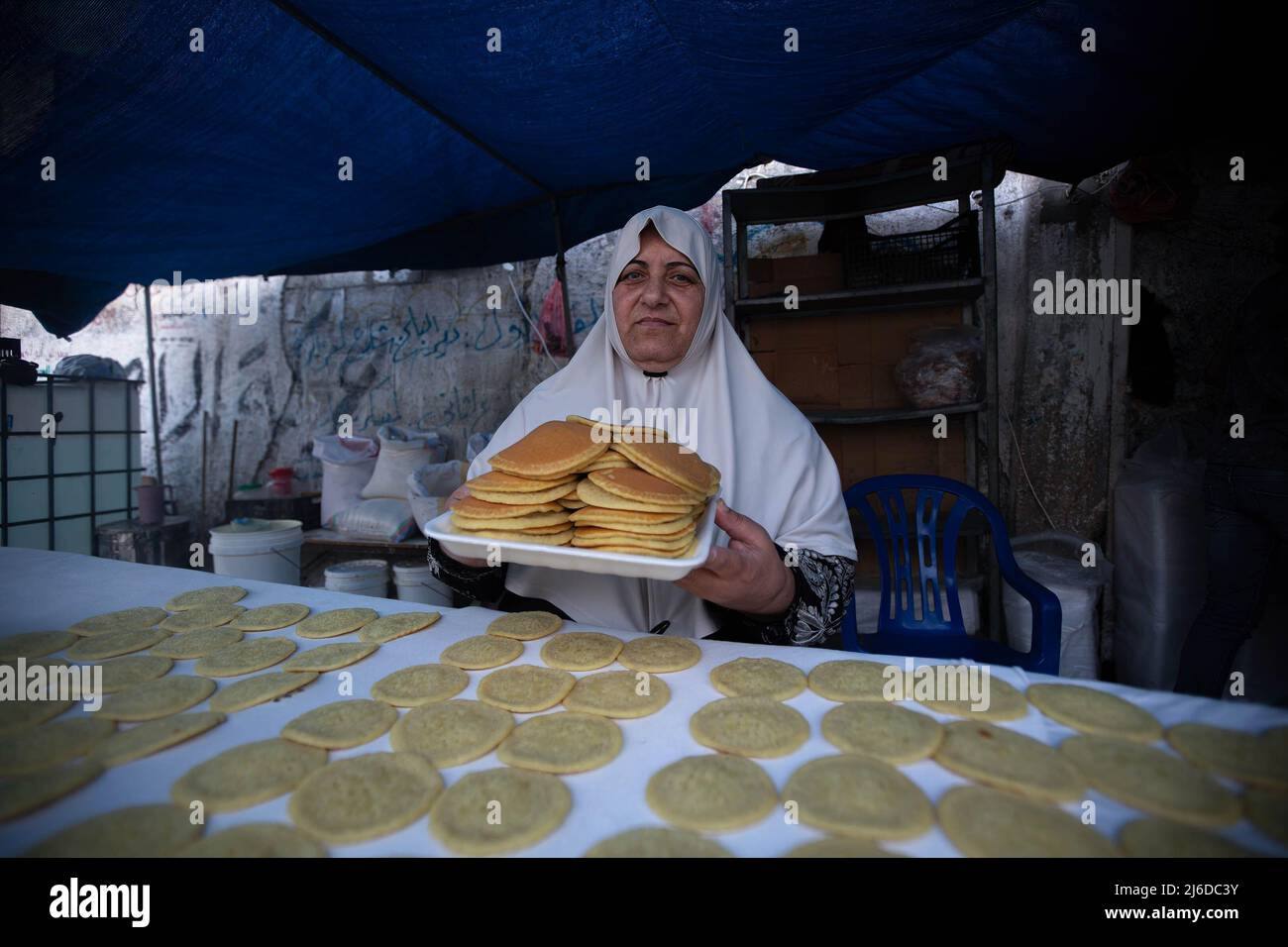 Palestinian Mariam Salha, 58, sells traditional sweets called "Qatayef ...