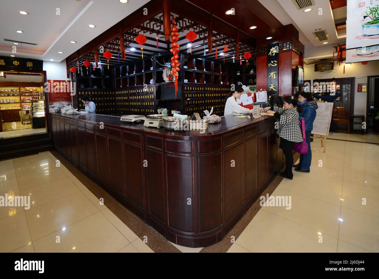 Pharmacist preparing herbal prescription at traditional Chinese ...