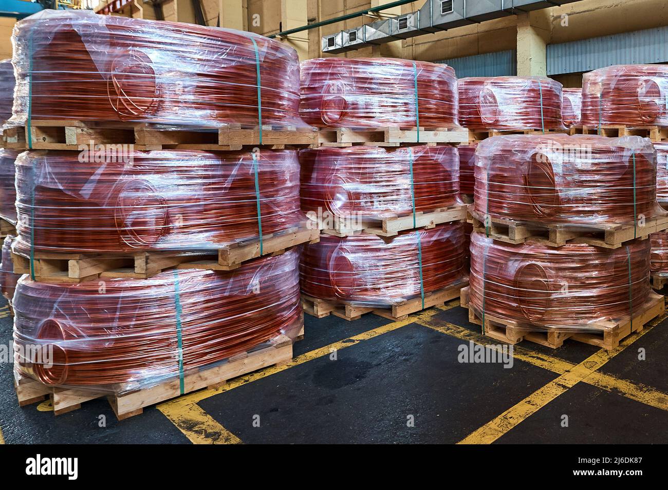 Coils of copper wire on wooden pallets in plant warehouse Stock Photo ...