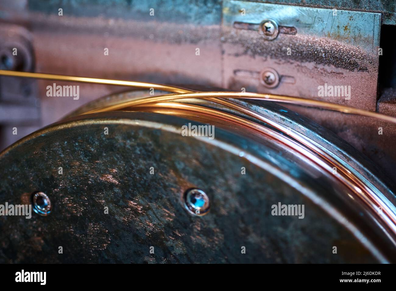 Copper wire straightener machine tool in plant workshop Stock Photo - Alamy
